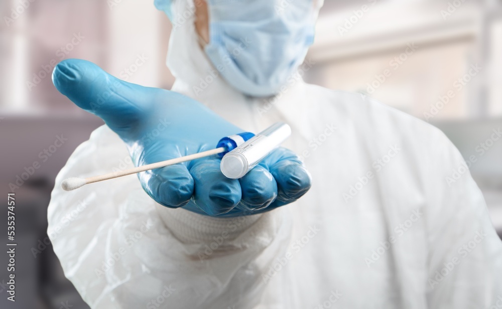 Medical laboratory assistant checks a test tube. Reproductive system ...