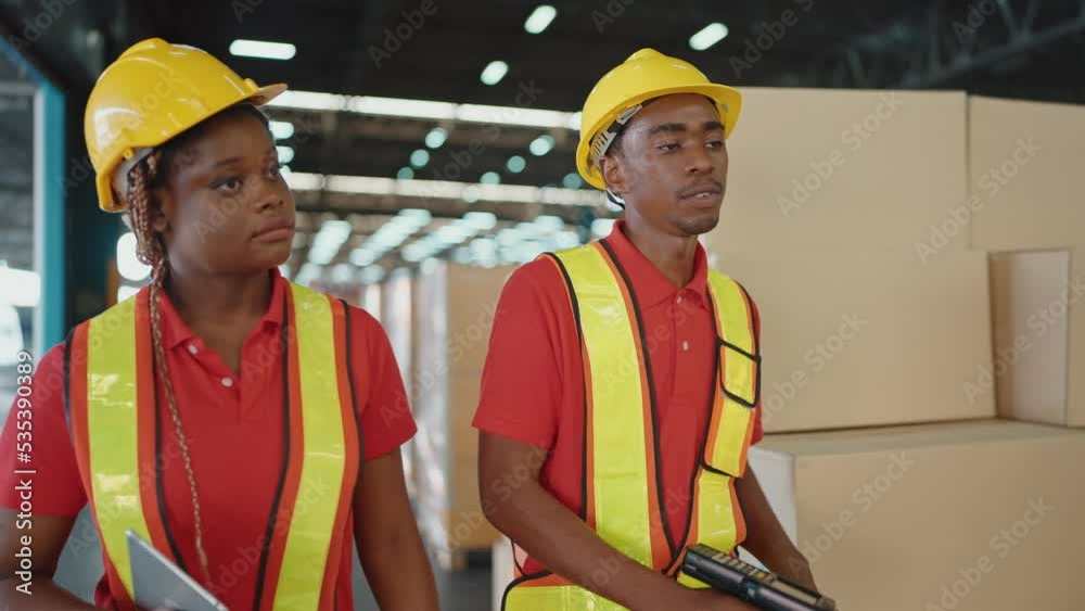 Two Young African American worker checking stock condition and scanning ...
