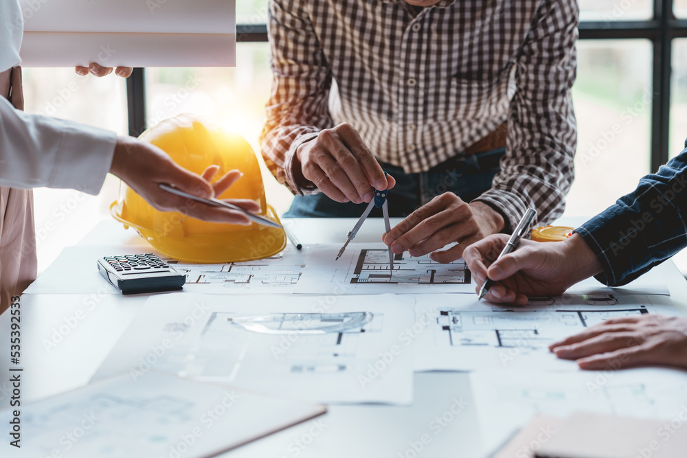 Project planning meeting engineers or architects drawing models working ...