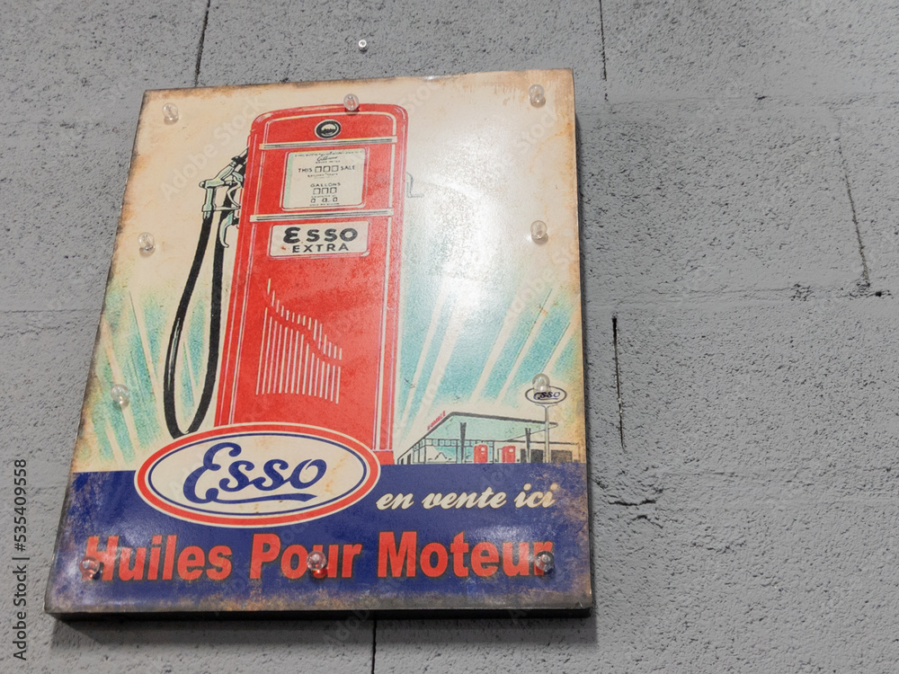 Esso extra exxonmobil group text sign and brand logo on old panel ...