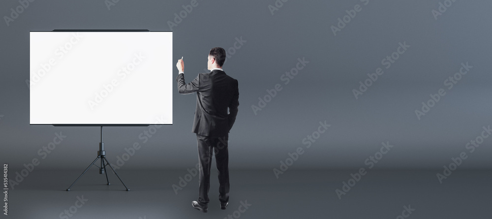 Business presentation concept with man in black suit back view in front ...