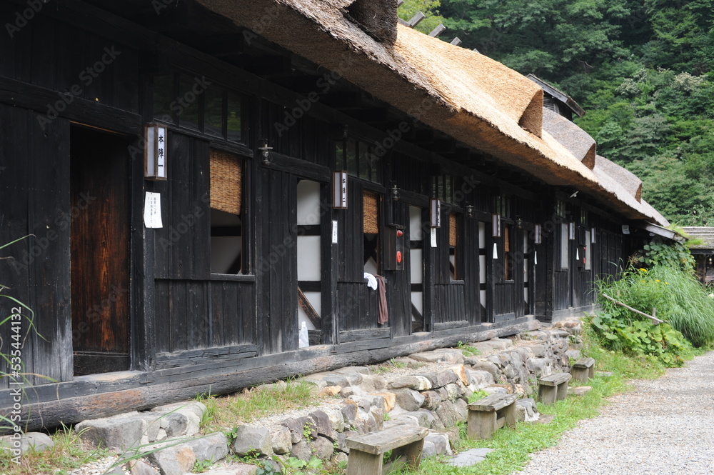 Wooden architecture at Nyuto Onsen hot spring in green mountain valley ...