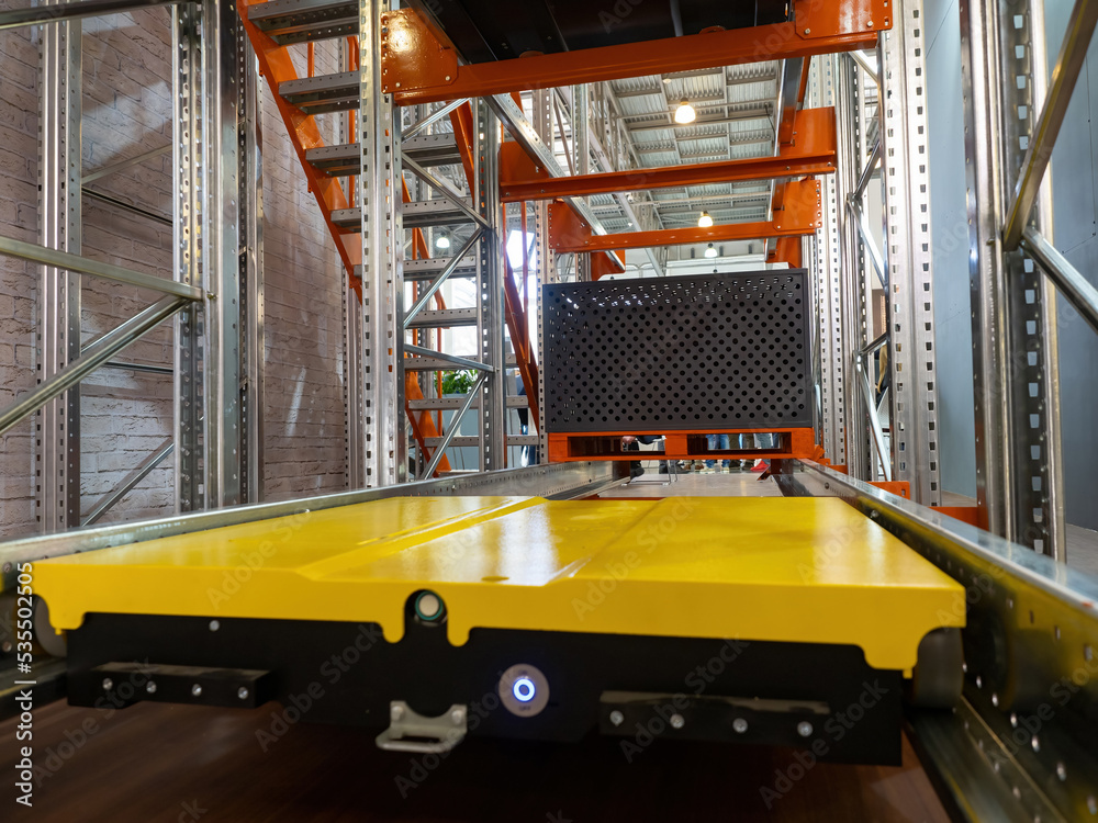 Warehouse robot on mezzanine. Warehouse robot for moving goods ...