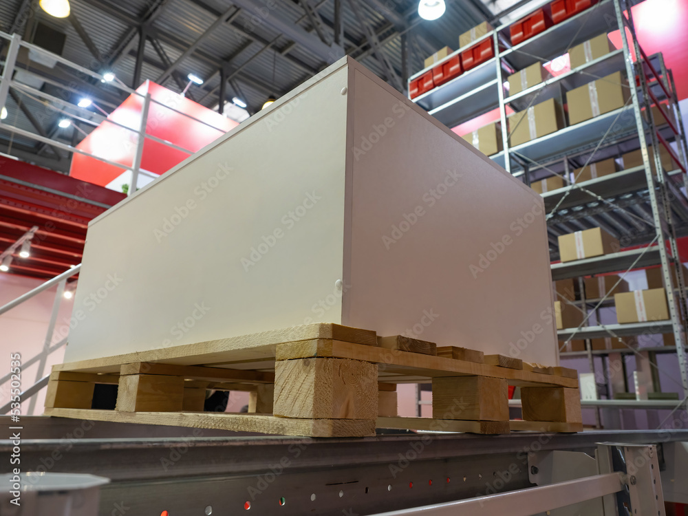 Furniture factory warehouse. Pallet by white wooden crate. Interior of ...