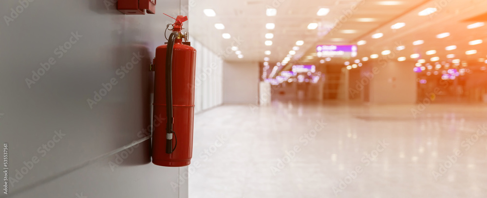 Dry chemical powder fire extinguisher in corridor. Install a fire ...