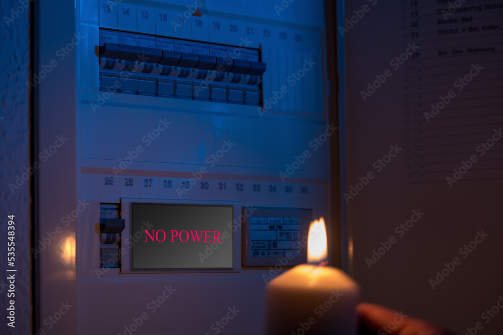 Electrical switch box panel with the text "no power" and burning candle ...