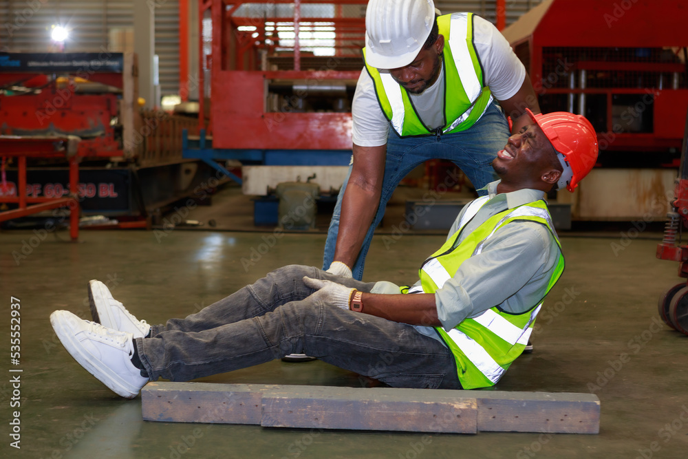 African American male worker helping colleagues Accident The legs are ...