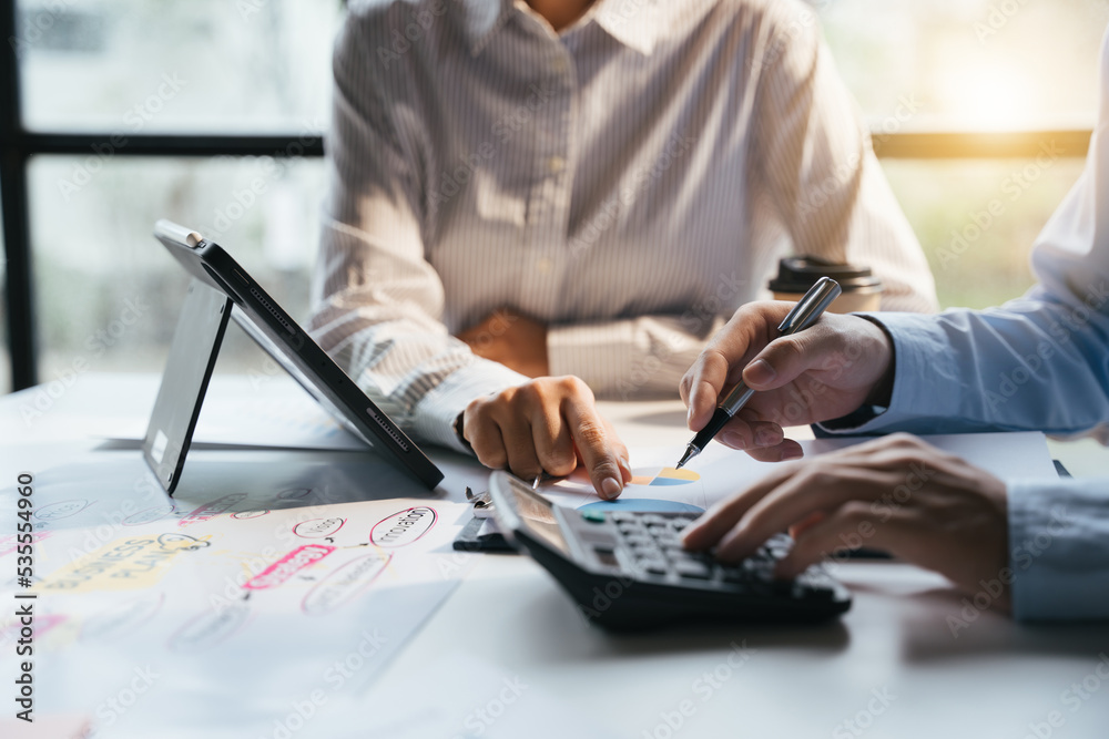 Teamwork with business people analysis cost graph on desk at meeting ...
