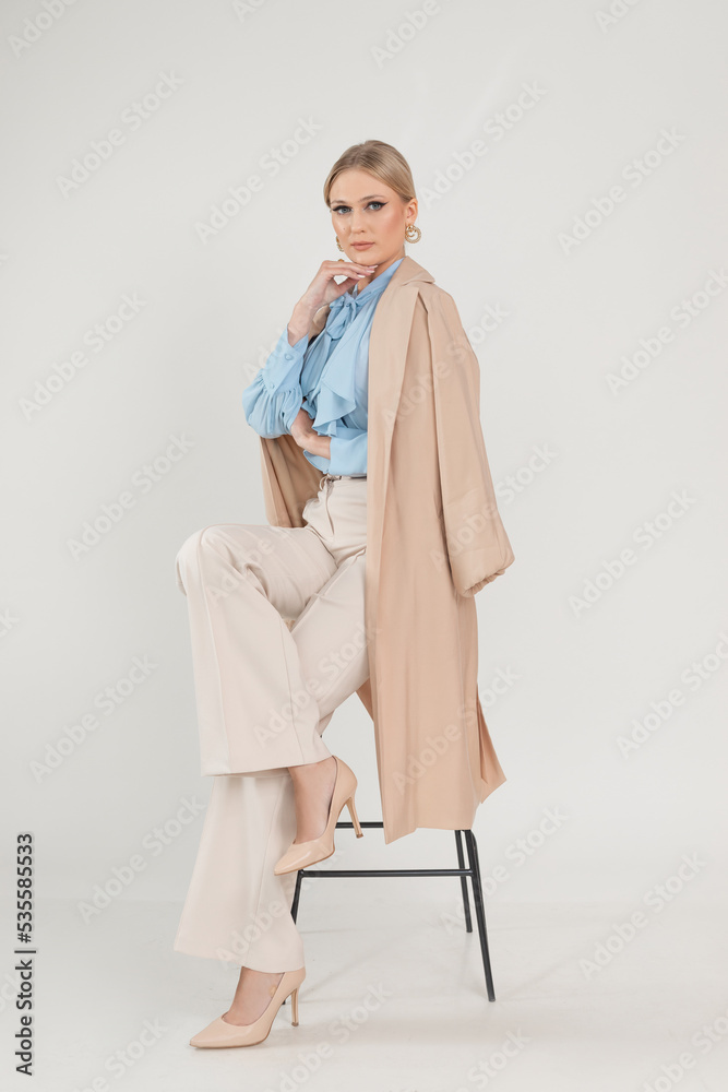 Full length photo of beautiful young woman sitting on chair in delicate ...