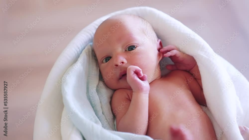 newborn. baby newborn a close-up lies looking at the camera in the ...