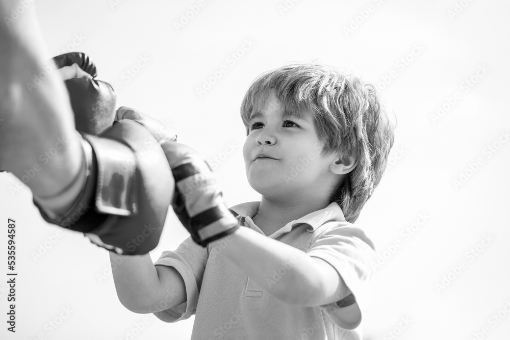 Father is training his son boxing. Little boy doing boxings exercise ...