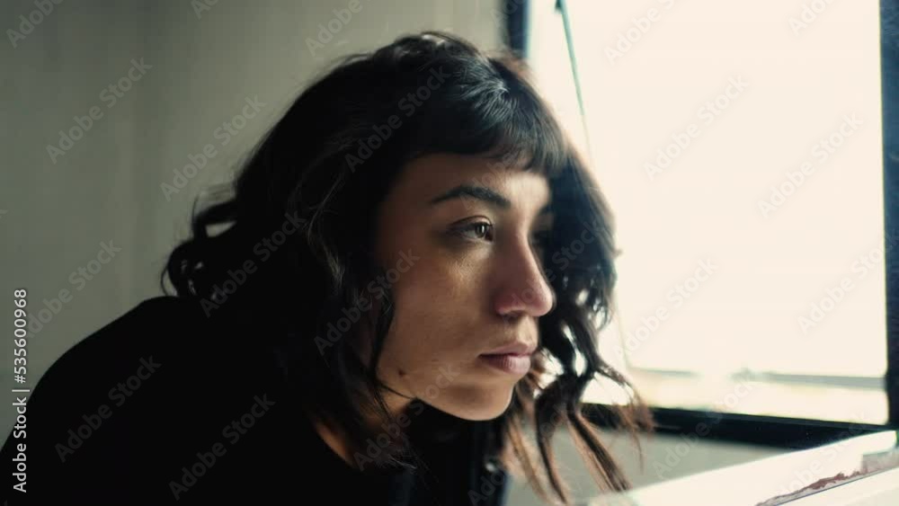 Depressed sad woman leaning on bathroom mirror looking at her own ...