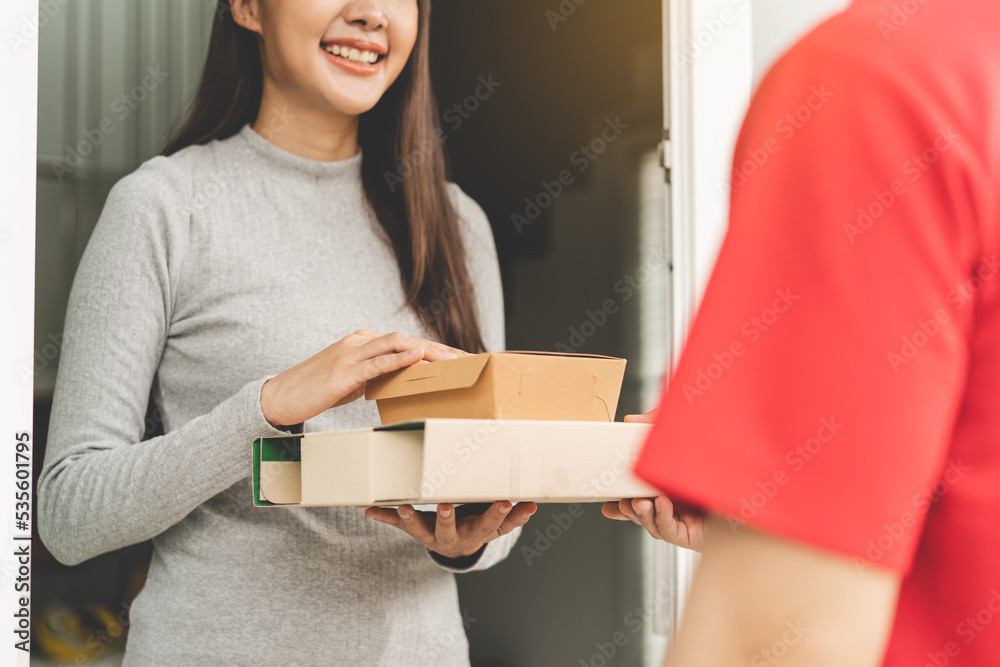Client receiving lunch box from delivery man at home. Stock Photo ...