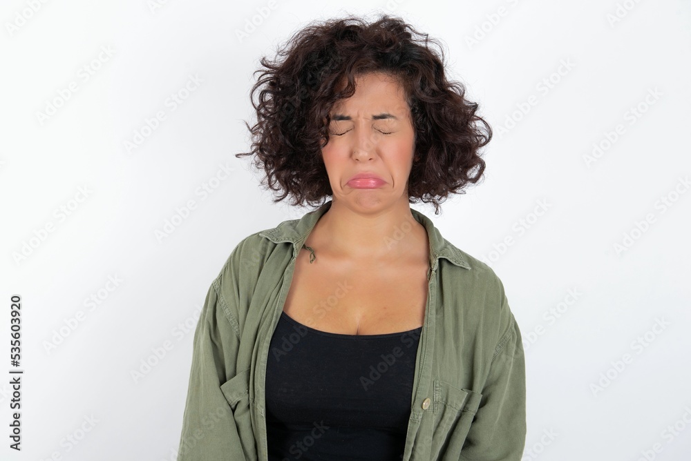Dismal gloomy rejected young beautiful woman with curly short hair ...