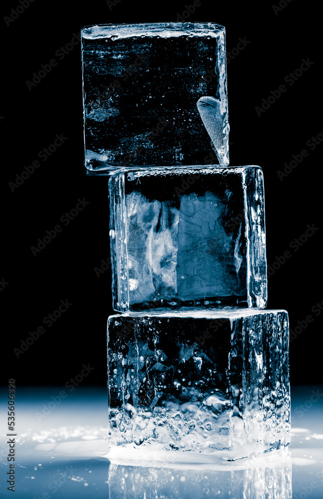 Pyramid of natural crystal clear ice cubes on black background. Stacked ...