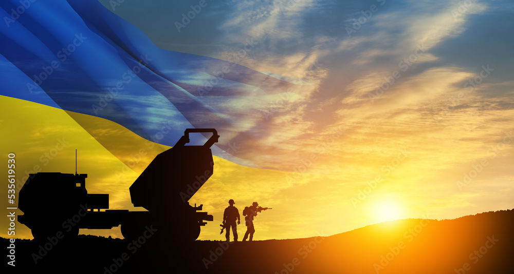 Artillery rocket system are aimed to the sky and soldiers at sunset ...