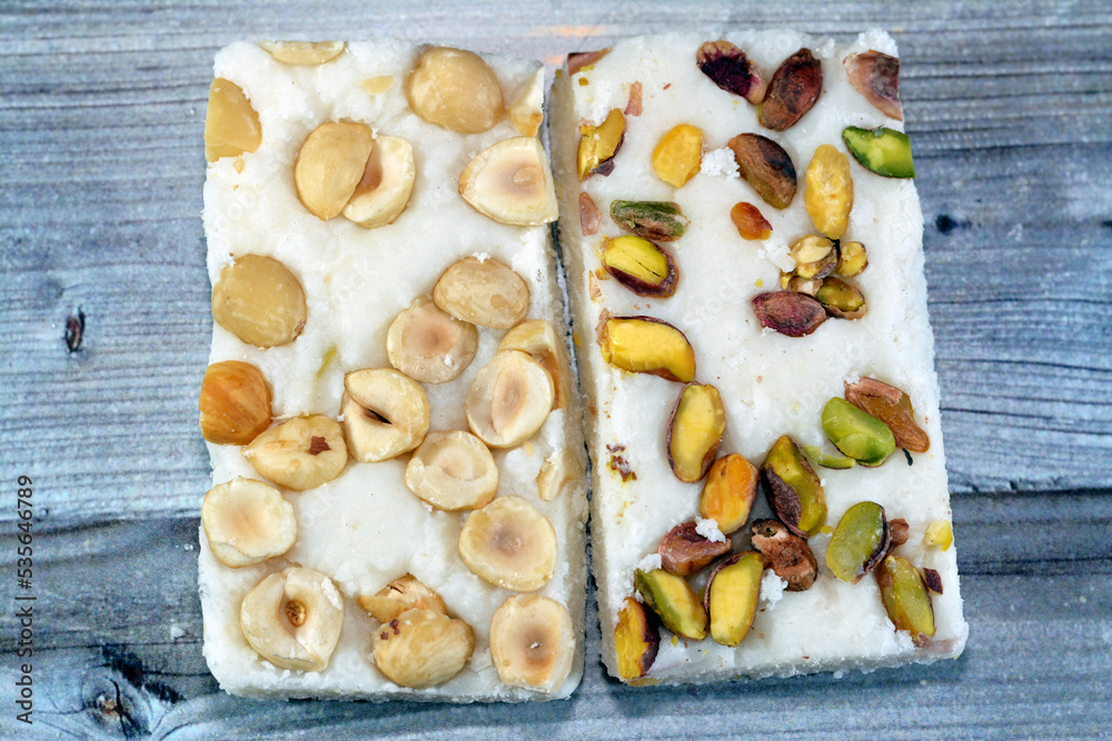 Arabian sweet candies of soft coconuts covered with pistachios and ...
