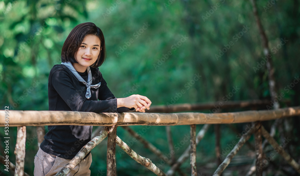 Protrait young woman looking beautiful nature while camping in forest ...