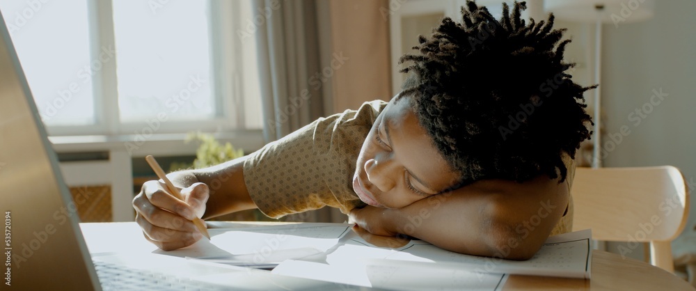 African American Black kid boy doing his homework or having a video ...