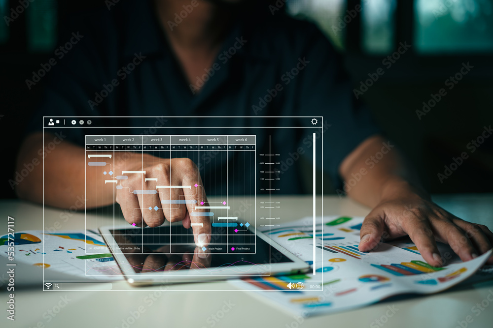 Businessman using Tablet with Gantt chart scheduling virtual diagram ...