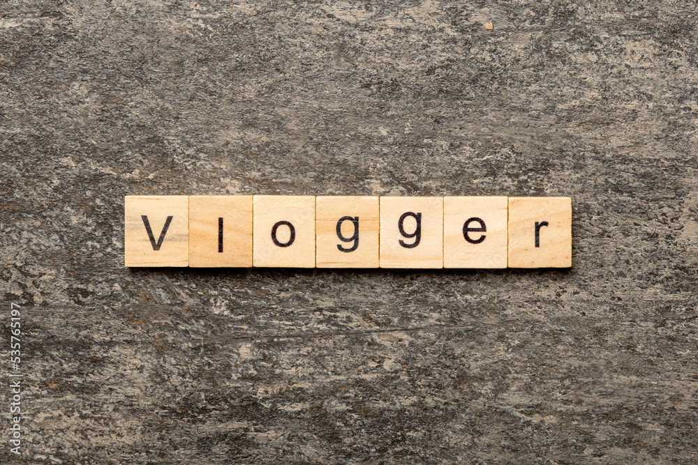 vlogger word written on wood block. vlogger text on table, concept ...