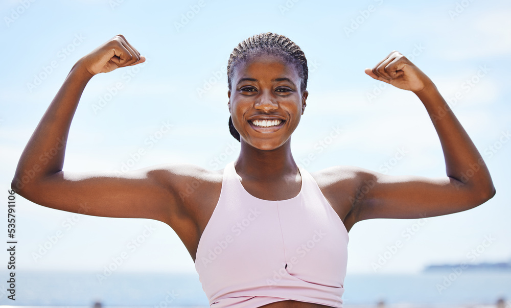 Strong black woman flexing arms, muscle and body power, fitness and wellness in urban Jamaica ...
