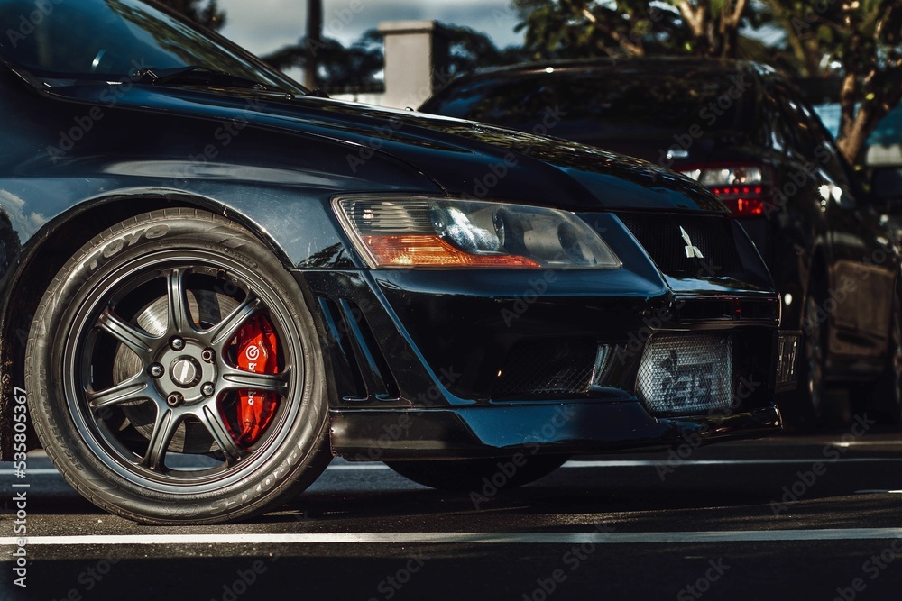 Profile view of the front rim of a dark blue Mitsubishi Evo 7 car in a ...