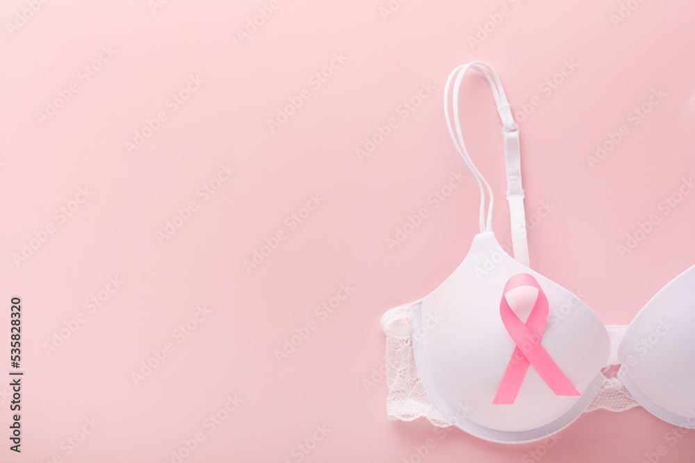 Breast Cancer Awareness Ribbon. White bra and pink ribbon tape lying on ...