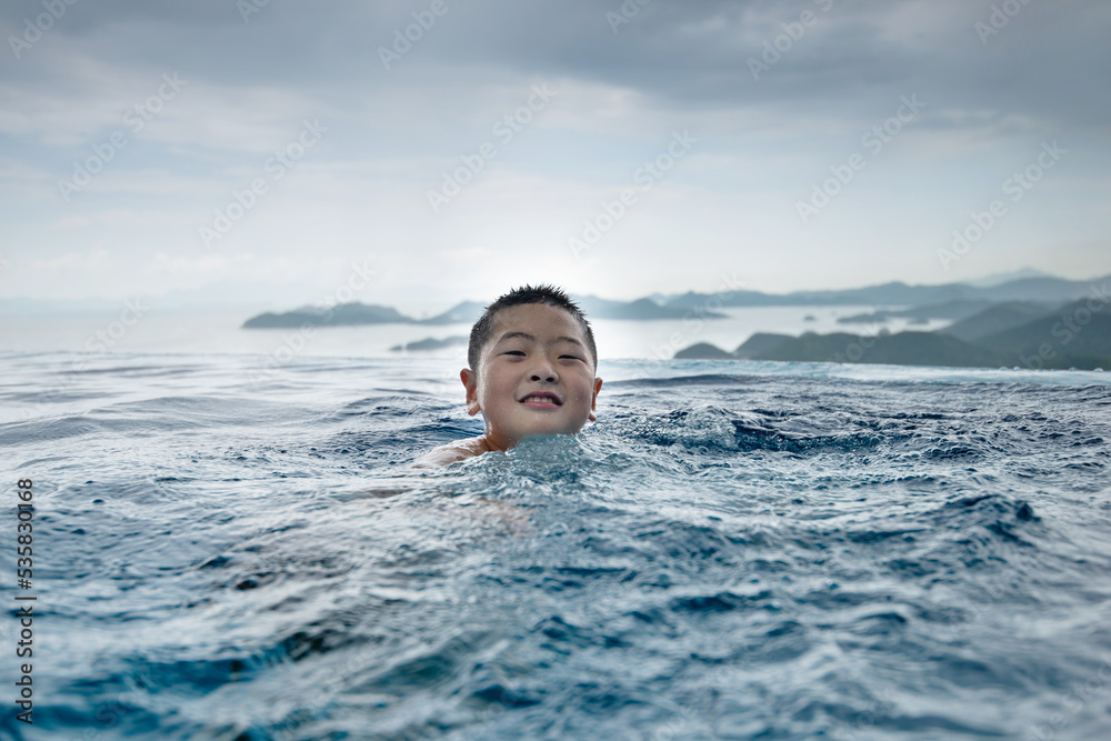 Boy swimming in the sea Stock Photo | Adobe Stock