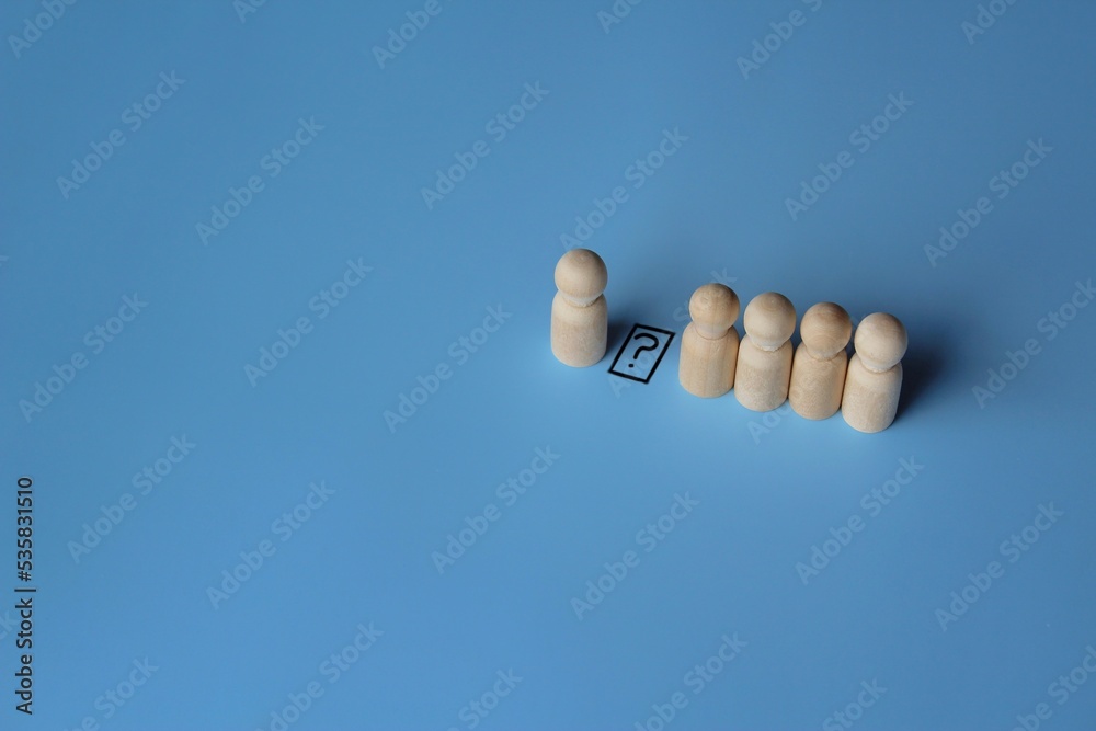 Wooden dolls and question mark. Missing in action, incomplete, partial ...