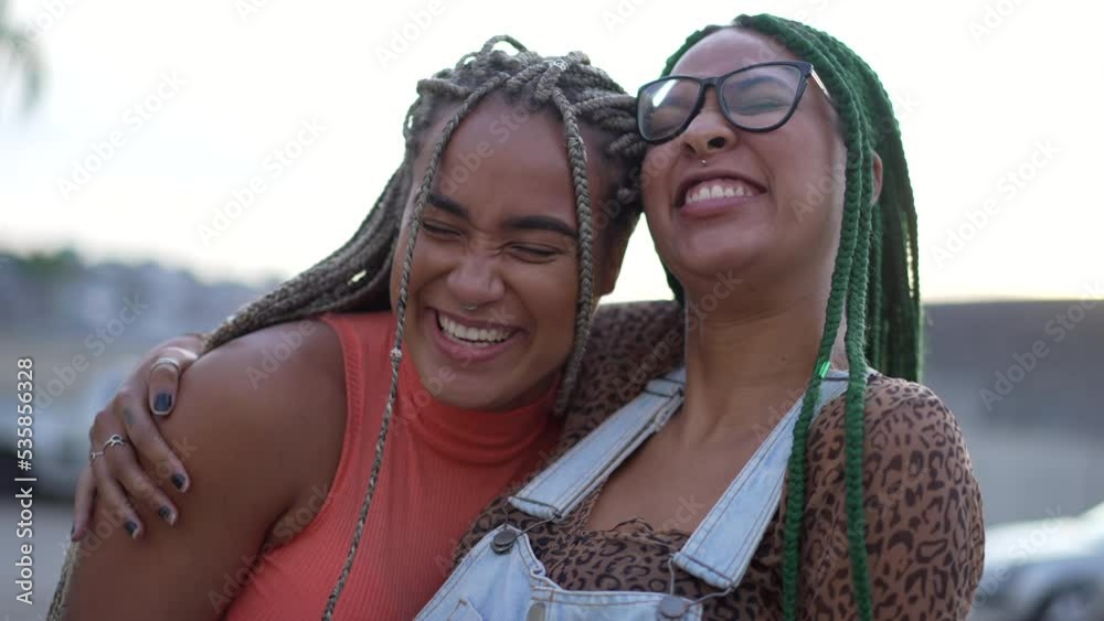 Two hispanic black women embrace. South American Brazilian sisters ...