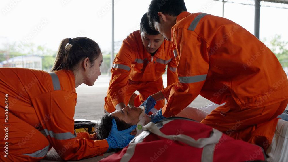 Emergency medical technician Asian woman (EMT) or paramedic team is ...
