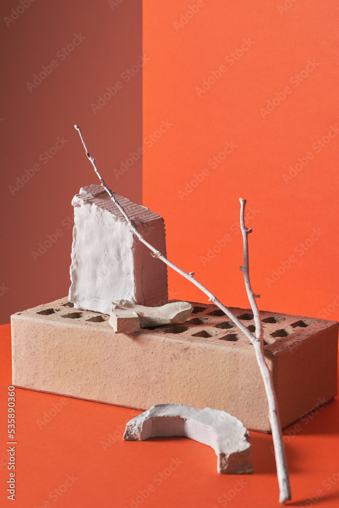 Vertical studio shot of creative still life installation of brick ...