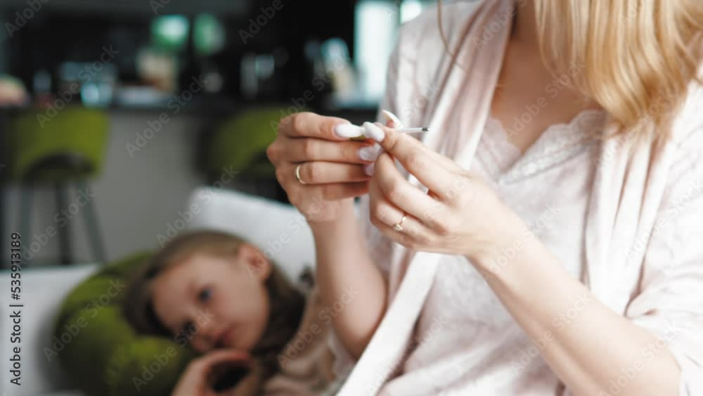 Sad worried upset mother measuring temperature, upset for her little ...