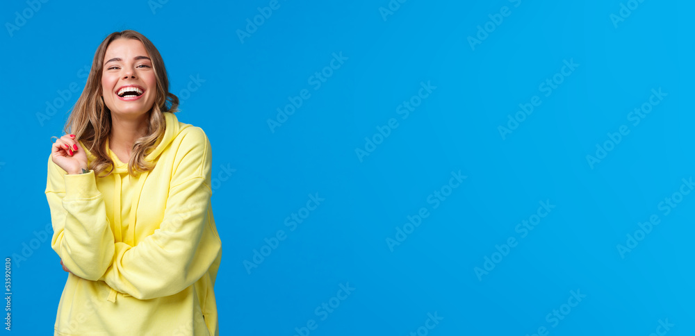 Happy blond young girl laughing from funny joke, having conversation ...