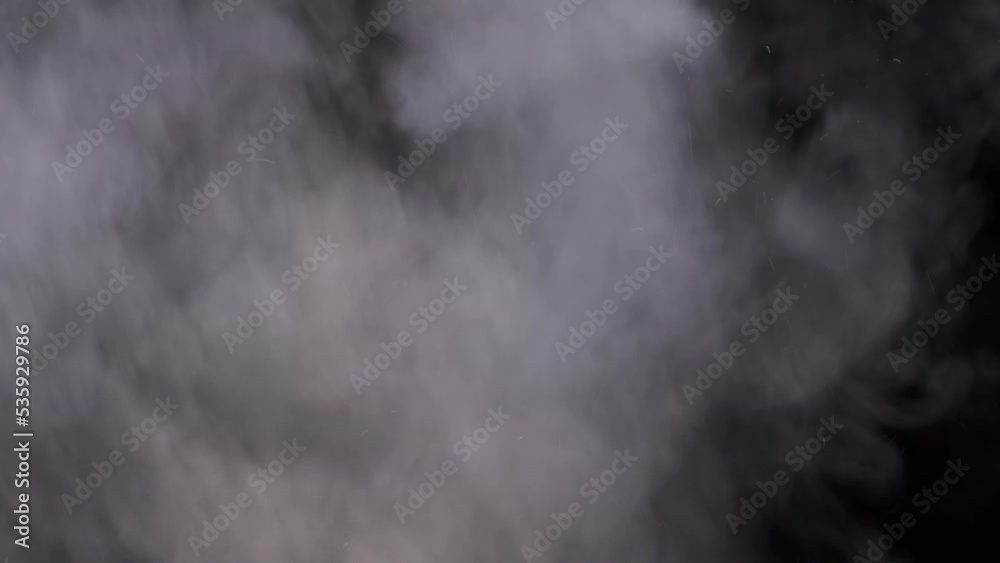 White smoke on black background. A cloud of vapor steam rises up ...