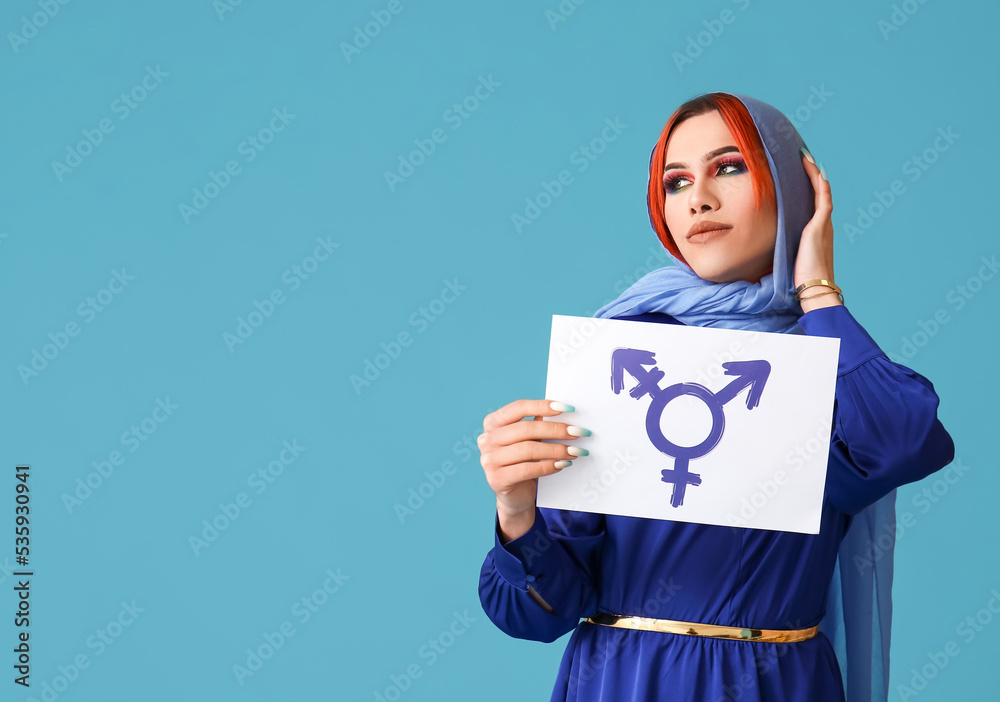 Stylish transgender woman holding paper sheet with transgender symbol ...