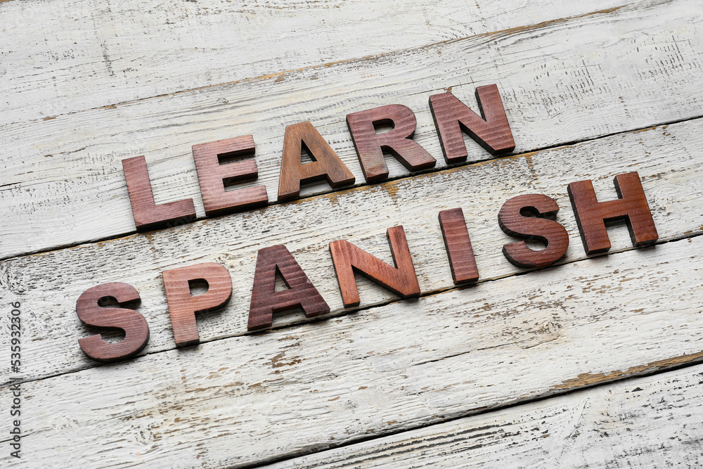 Text LEARN SPANISH on white wooden background Stock Photo | Adobe Stock