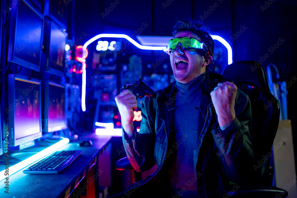 Foto de Caucasian Gamer man with hitech clothes and eye glasses show ...