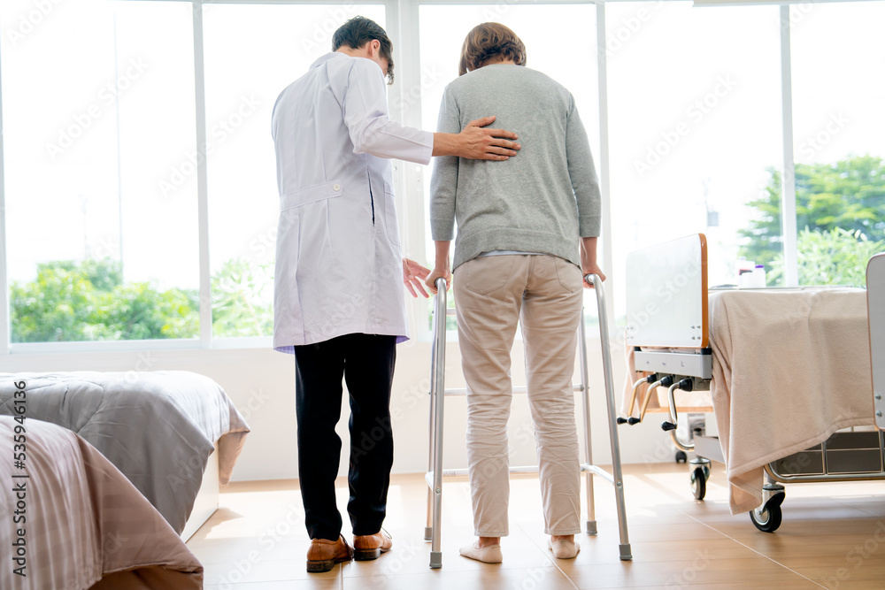 Young doctor help with handle gently and support senior patient woman ...
