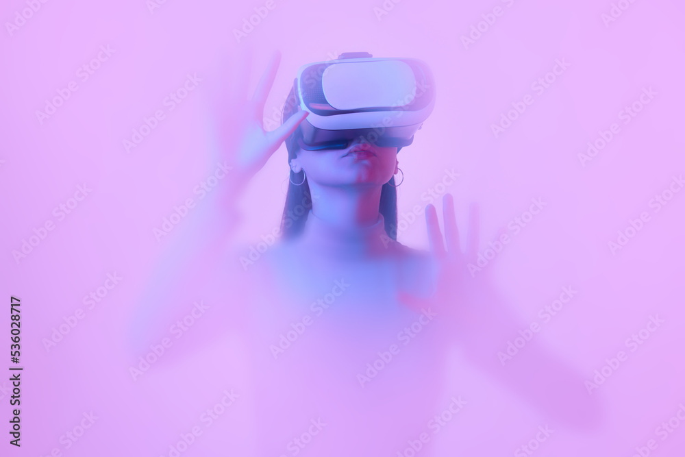 Virtual reality. Young girl in VR eyewear, immersed in clouds of smoke ...