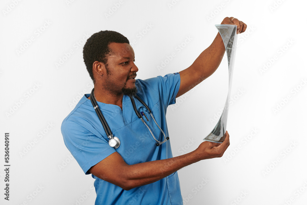Black surgeon doctor bearded man in blue coat with stethoscope holds X ...