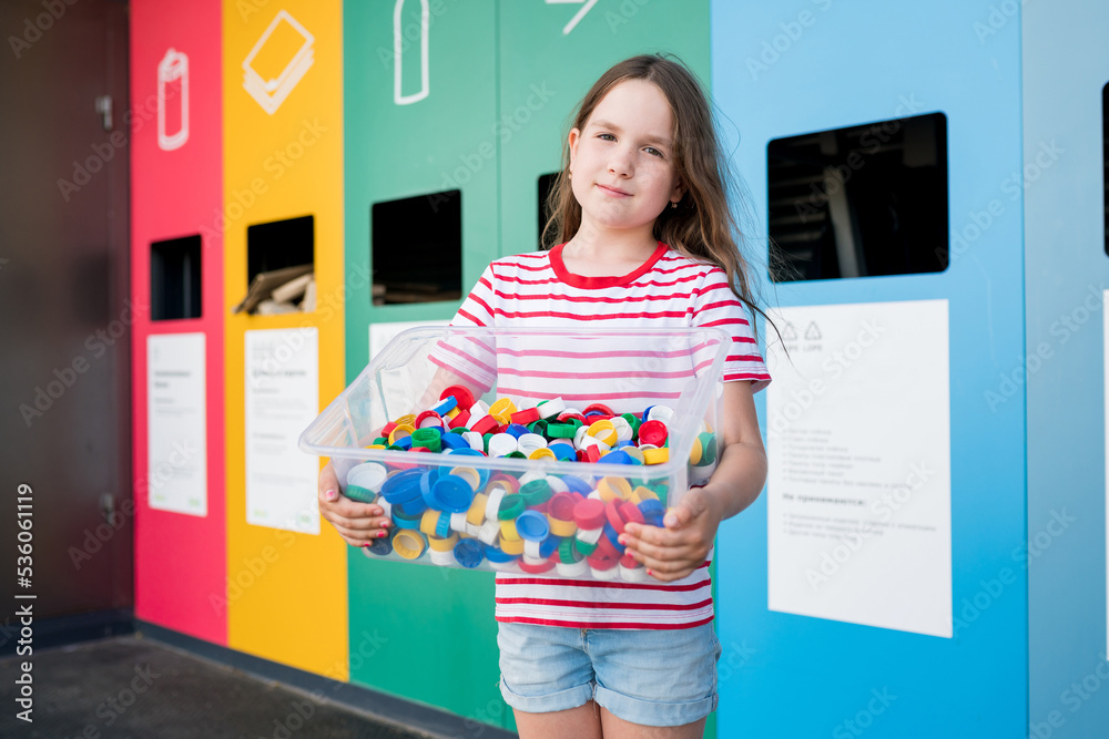 Girls holding container with plastic bottle caps. Kids collecting ...
