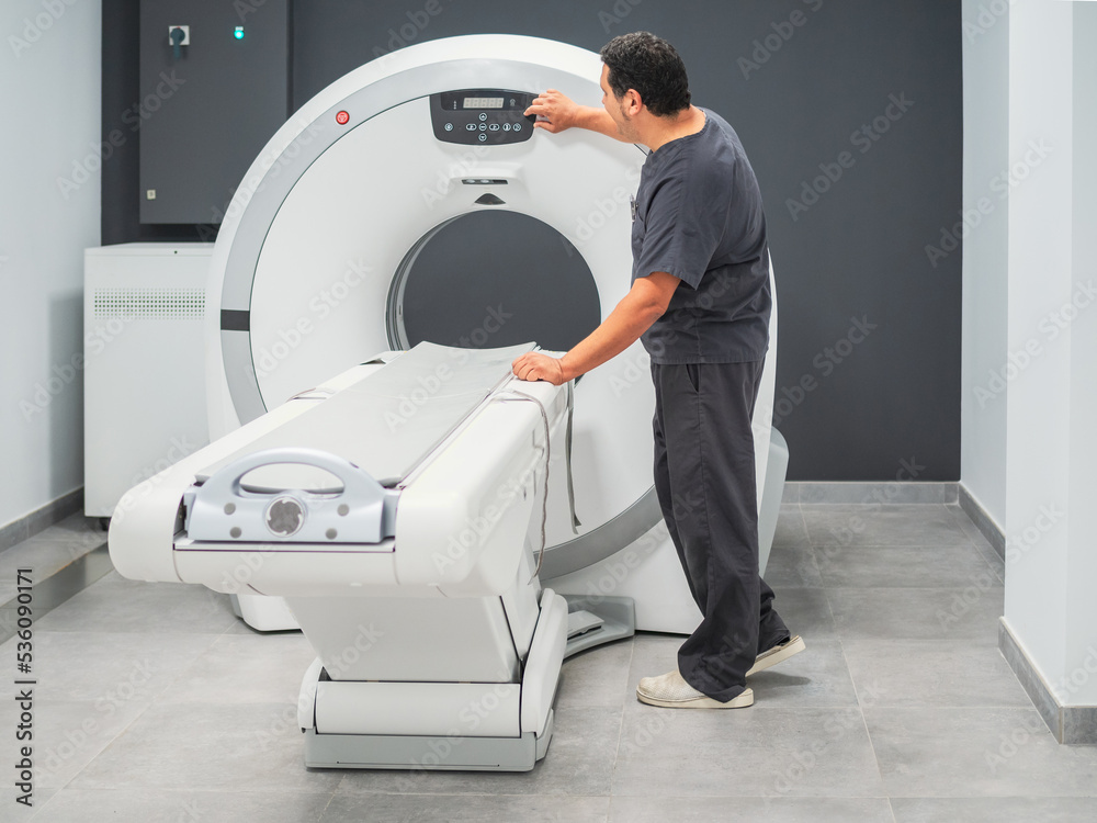 Doctor operating MRI scanner in hospital Stock Photo | Adobe Stock