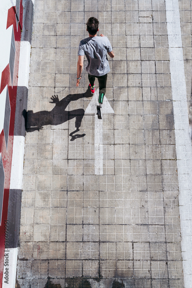 Athlete with artificial leg running up slope Stock Photo | Adobe Stock