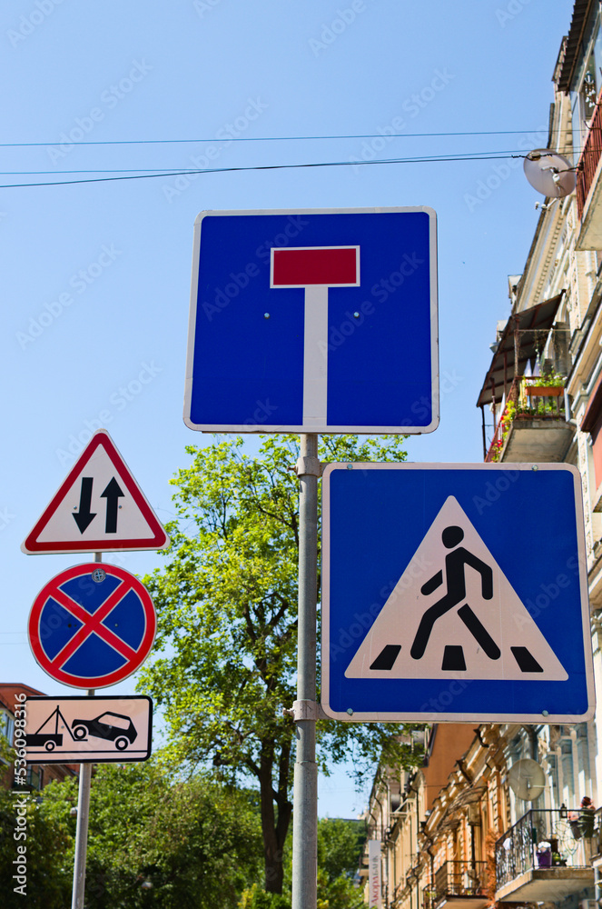 Group of traffic signs on the poles. Concept of road sign in big city ...