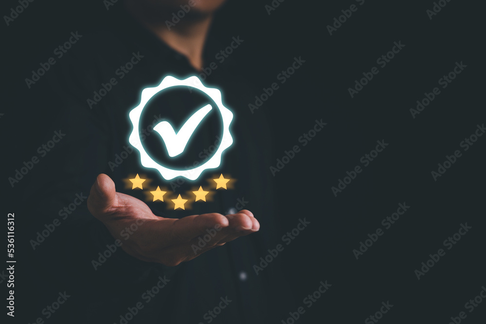Businessman holding and showing the best quality assurance with golden ...