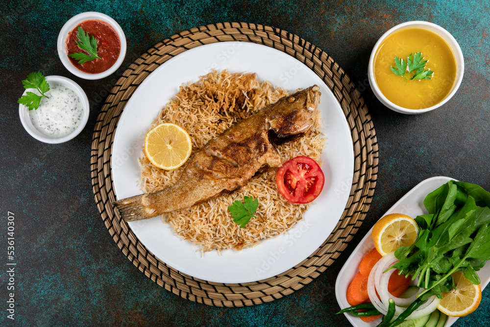 Arabian Sheri fish mandi rice with lemon slice served in dish top view ...