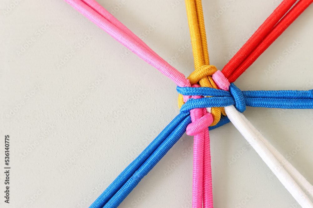 Concept image of unity and teamwork. Ropes tied together as a symbol of ...