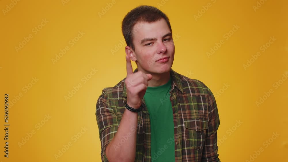 Displeased man shakes finger and saying no, be careful, scolding and ...